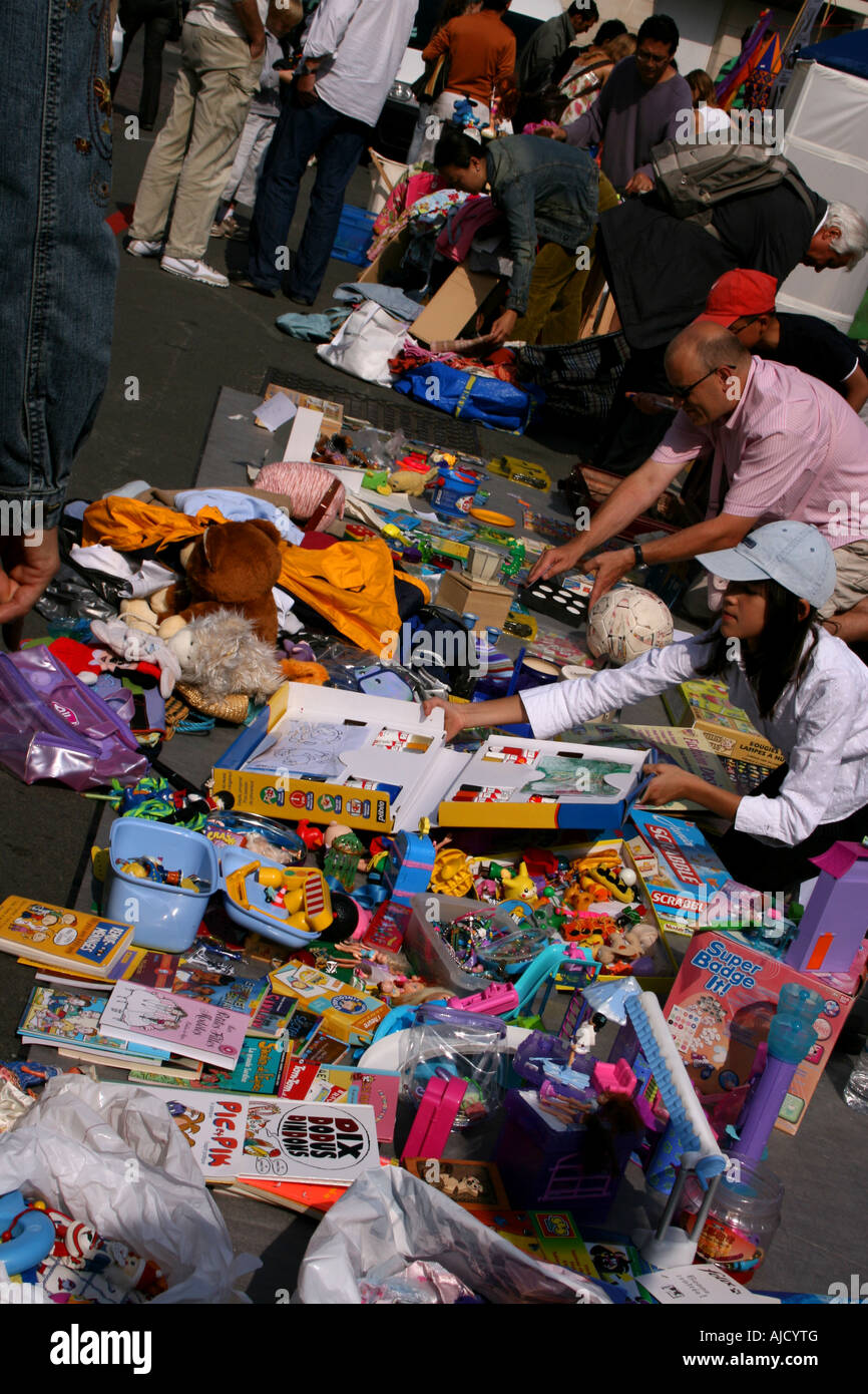 People looking through items laid out on blankets on the floor at the ...