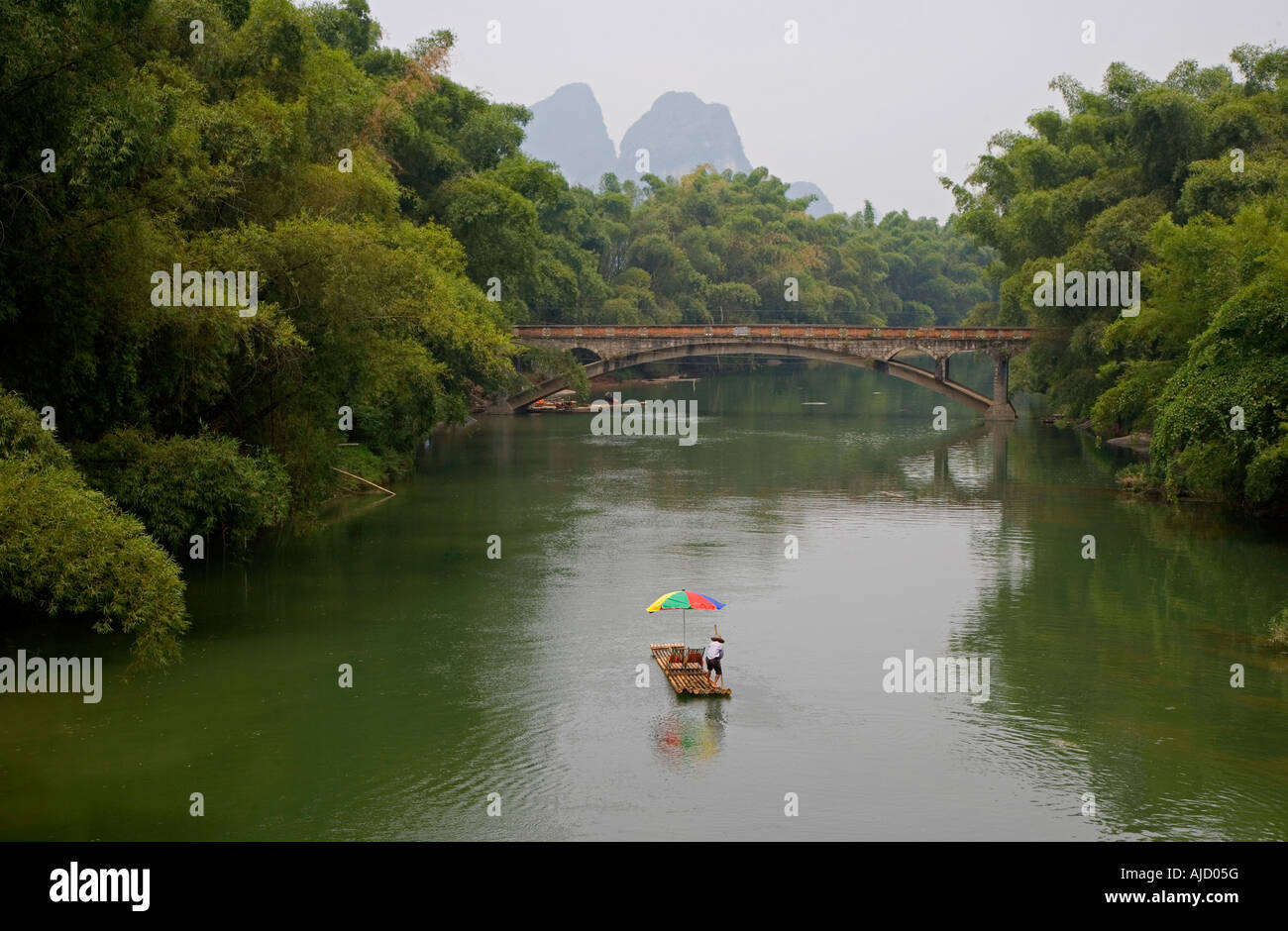 a lone bamboo raft on paddling on the Yulong River in Guilin China ...