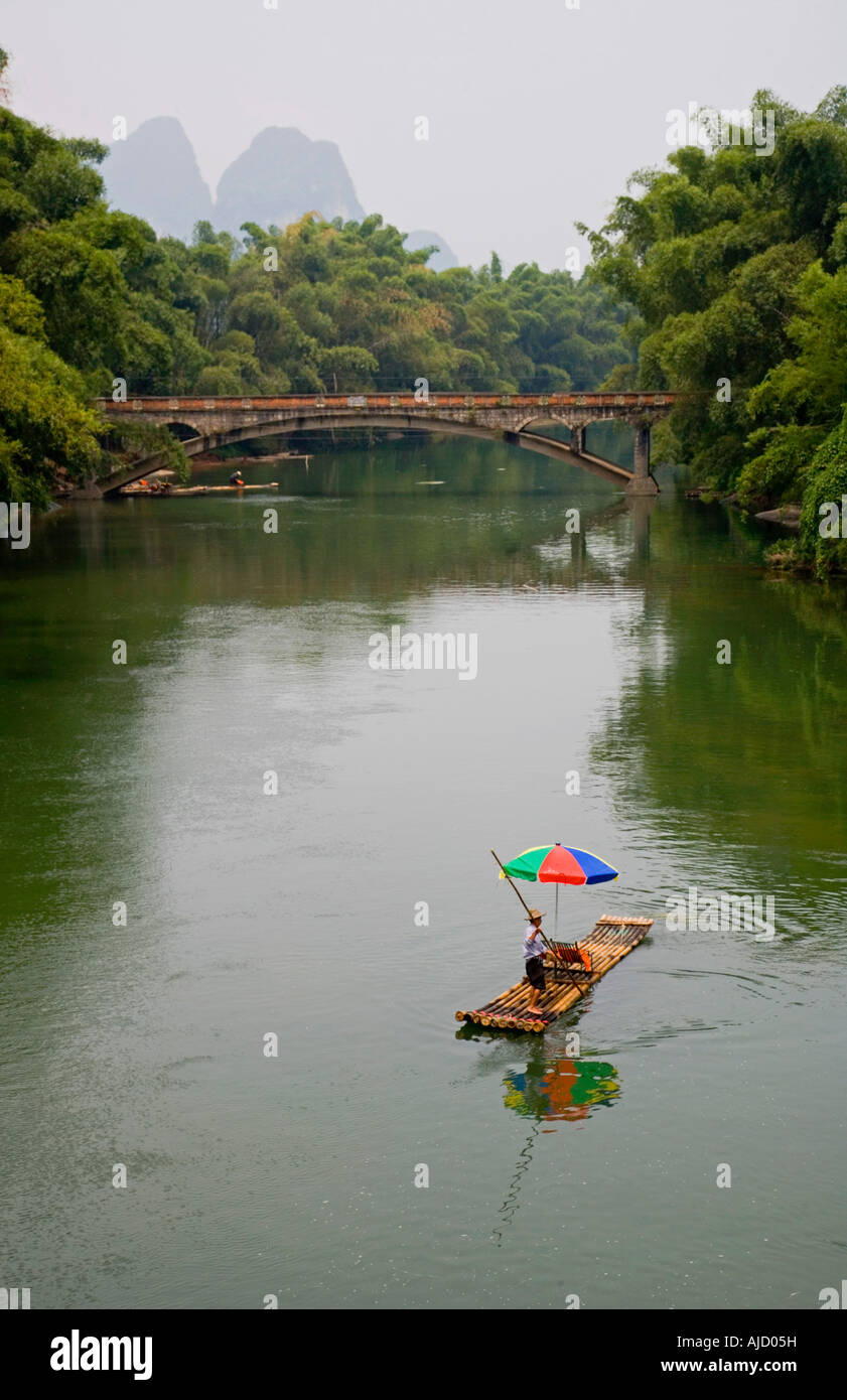 postcard perfect, a lone bamboo raft paddling on the Yulong River in ...
