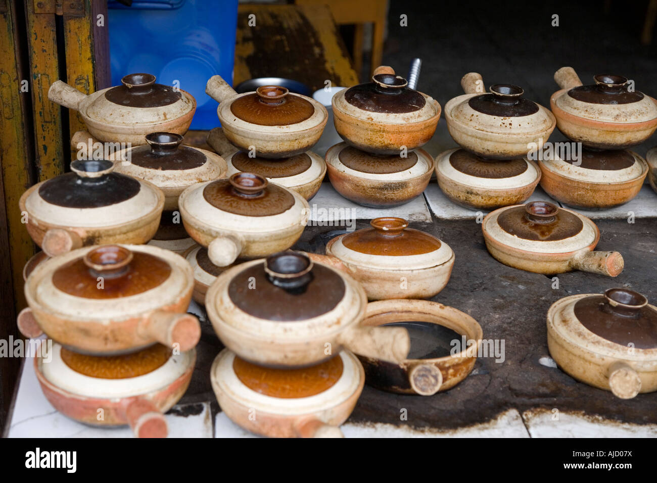 ceramic pots with cooked rice at streetside diner in Guilin China Stock ...