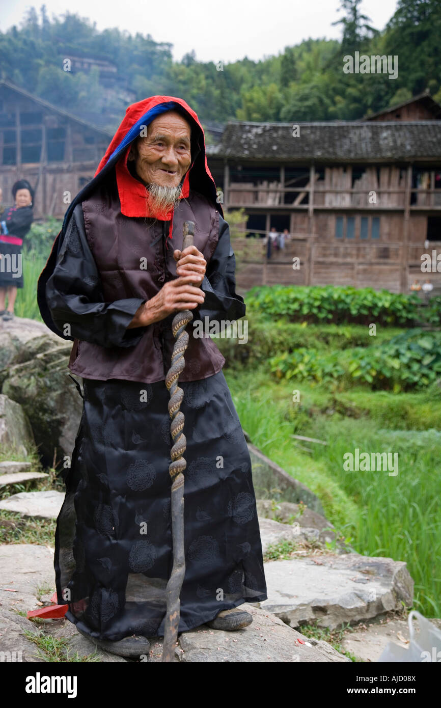 Red Yao village headman in traditional dress for greeting visitors ...