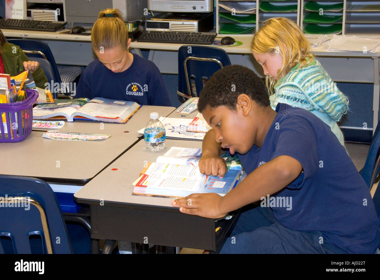 Fourth grade students read textbooks in a classroom at a public school ...