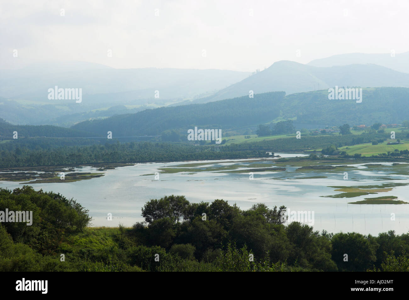 River Rio Nansa and hazy Sierra de Pena Sagra mountains Cantabria Spain ...