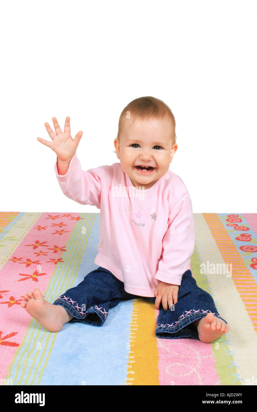 laughing baby sitting on a blanket, beckoning, Switzerland Stock Photo ...