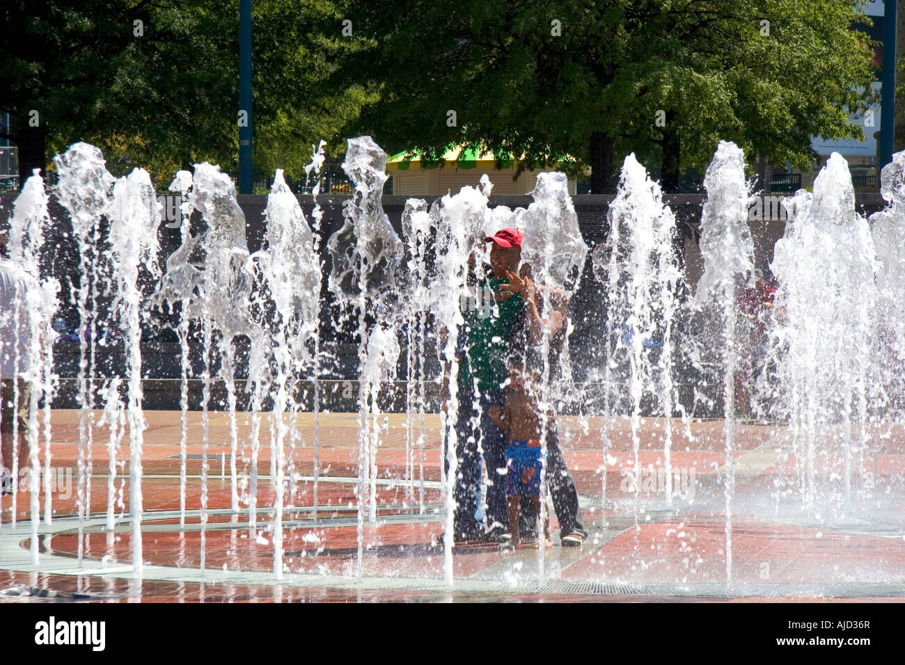 People get wet in the Fountain of Rings in Centennial Olympic Park ...