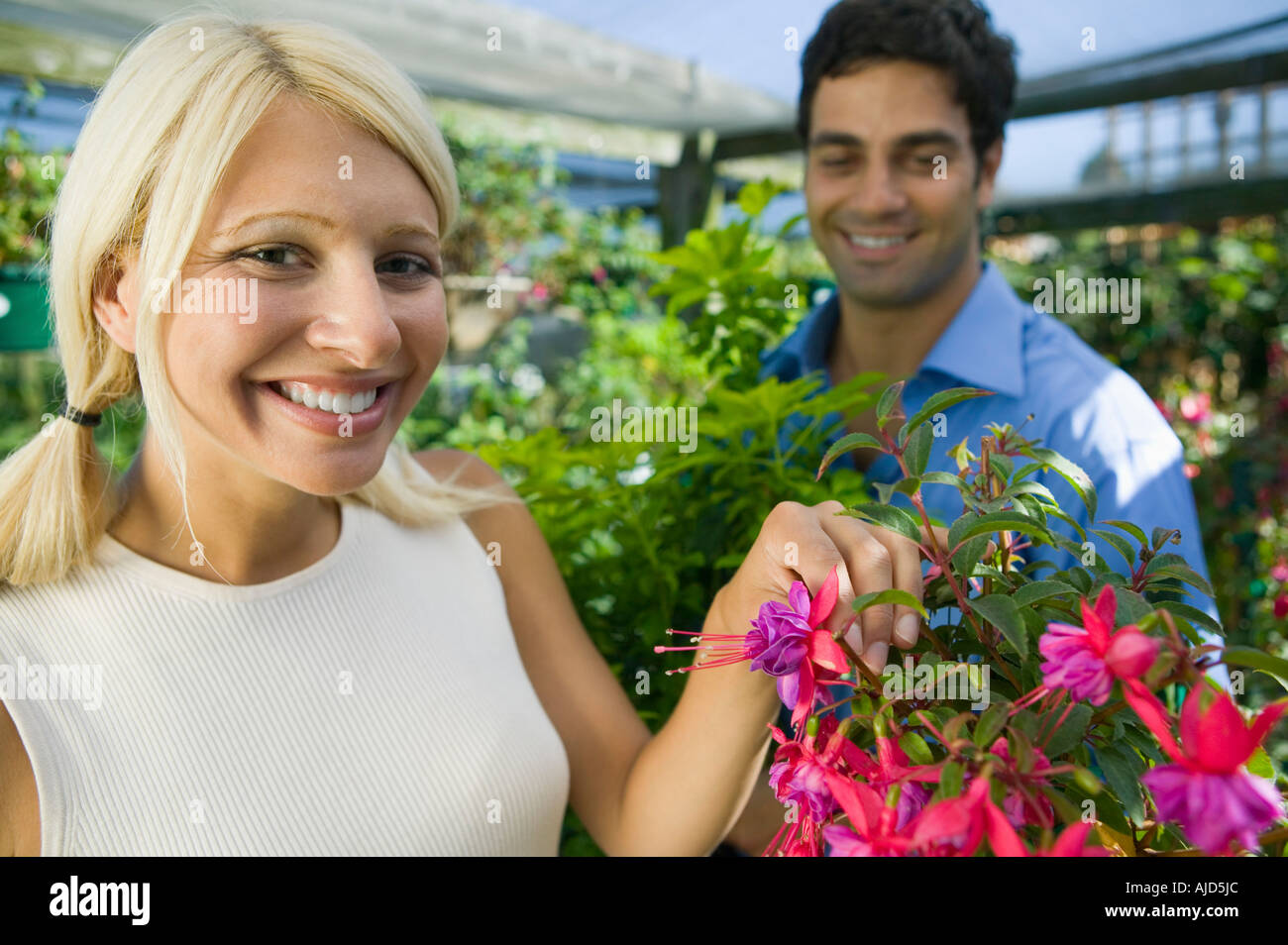 Woman selecting Flowers in plant nursery, portrait Stock Photo - Alamy