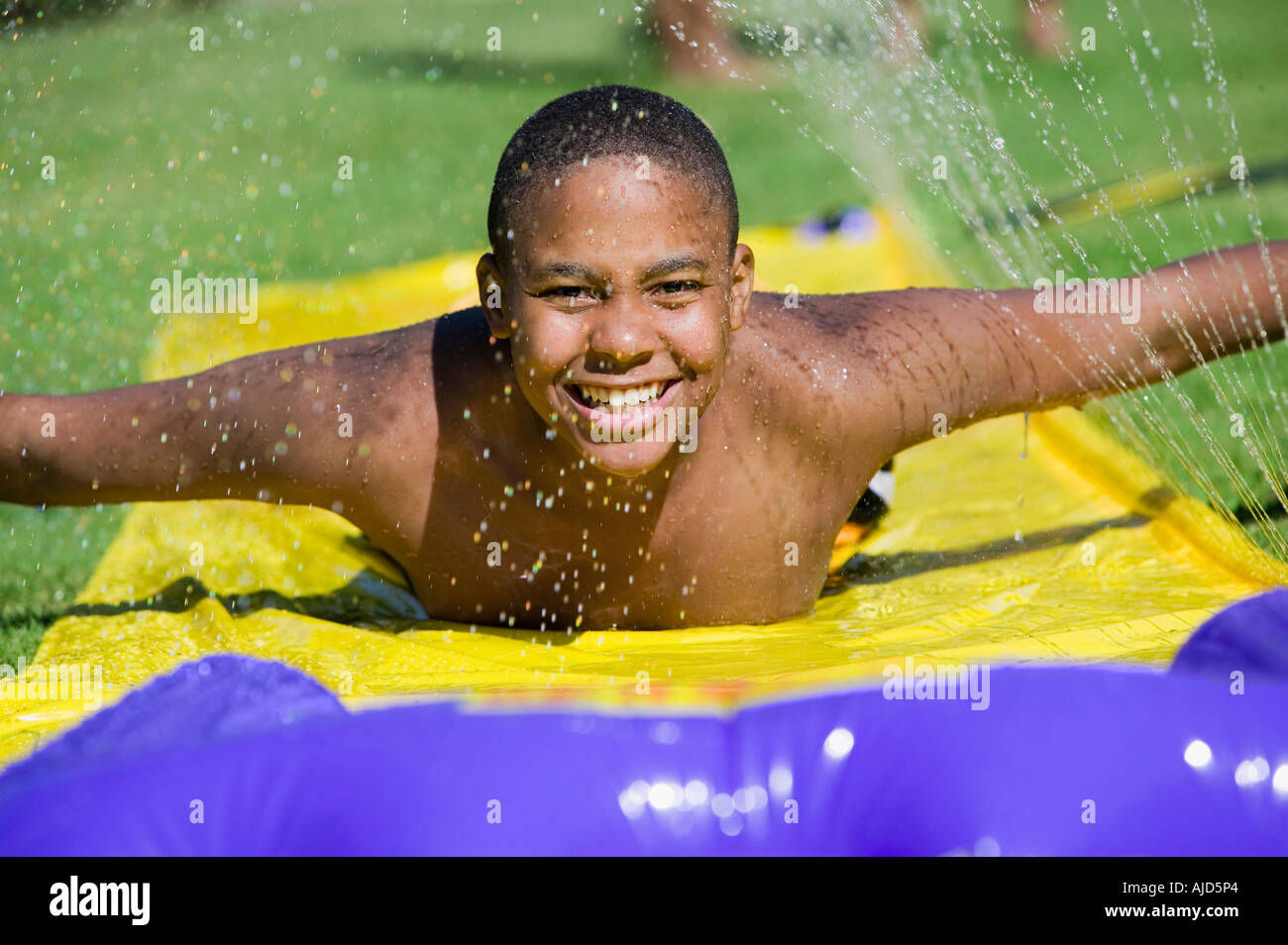 Children sliding down water slide hi-res stock photography and images ...