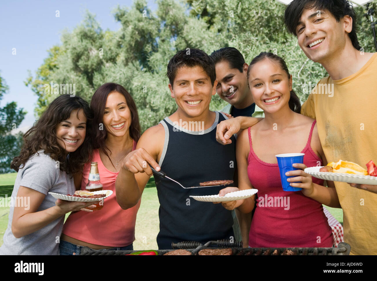 Gathered around grill group hi-res stock photography and images - Alamy
