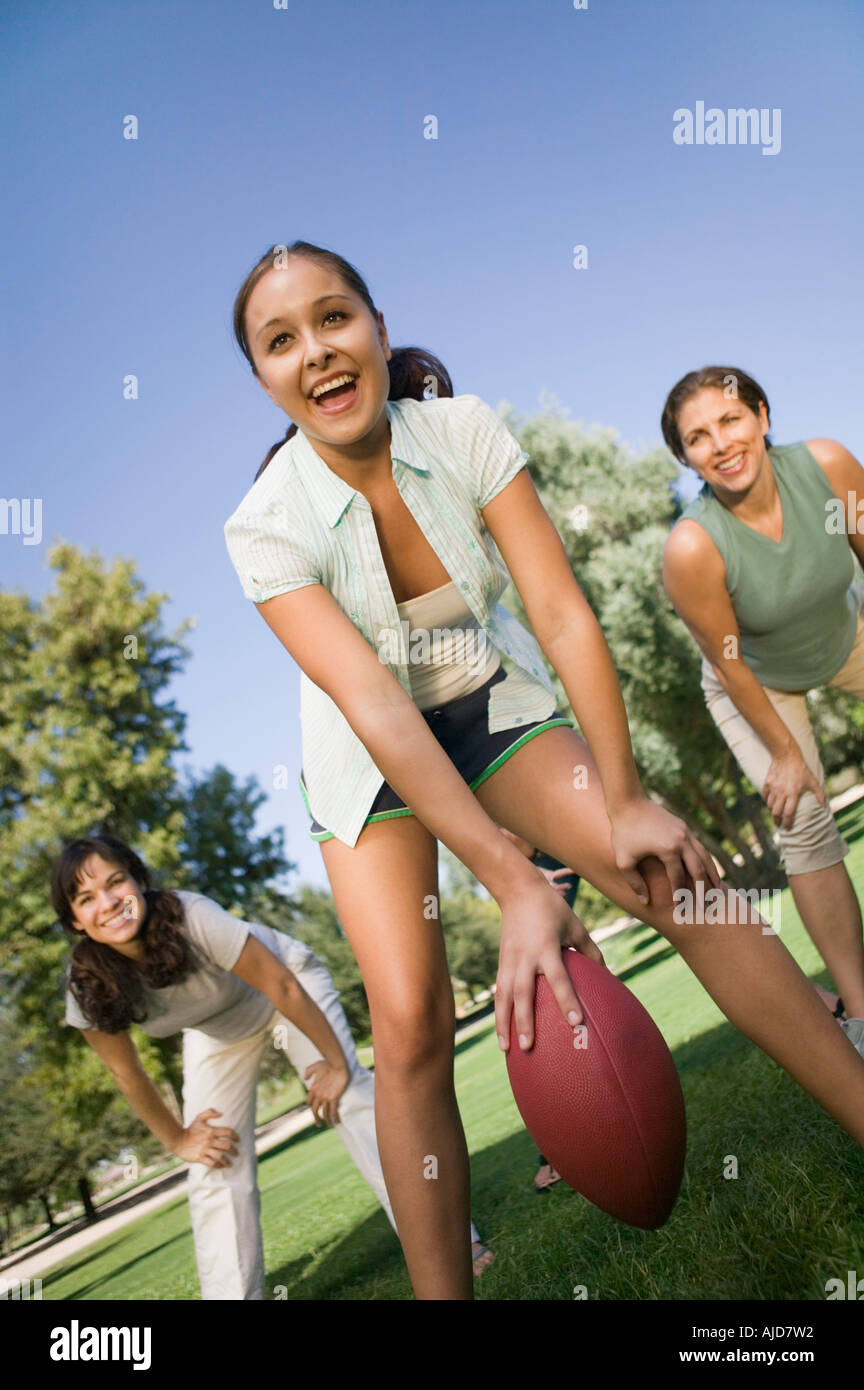Three women playing football outdoors Stock Photo - Alamy