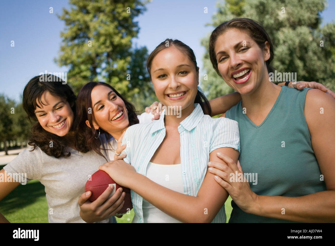 Four women playing football outdoors Stock Photo - Alamy