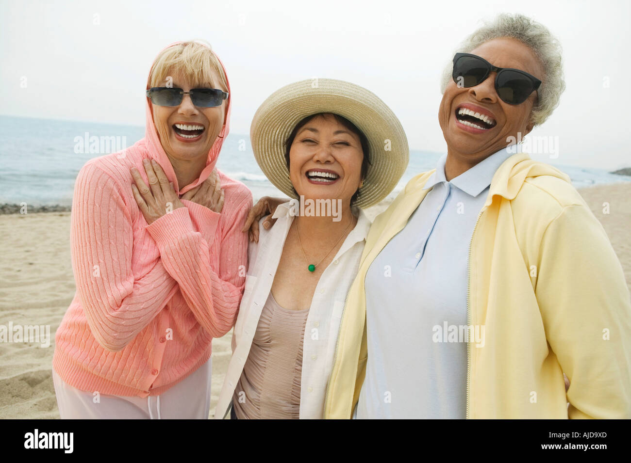 Female friends laughing at beach, (portrait Stock Photo - Alamy