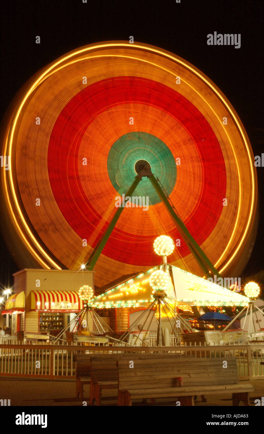 Vertical color image of a Ferris wheeel at an amusement park at night ...