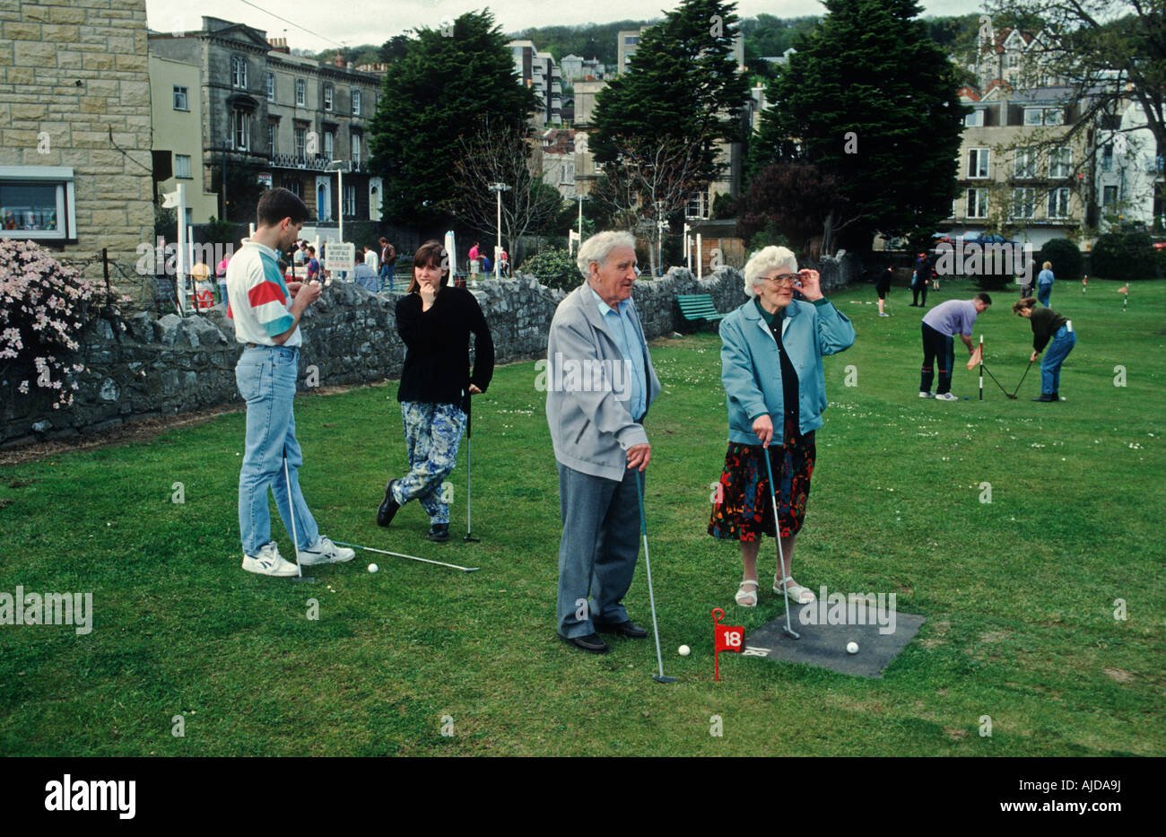 Bank holiday makers playing mini golf by the seaside Stock Photo - Alamy