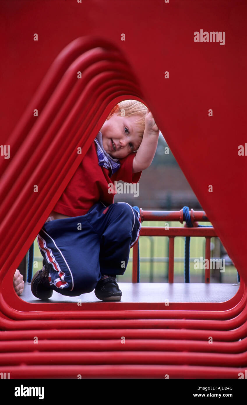 One Child playing triangular climbing frame Stock Photo - Alamy