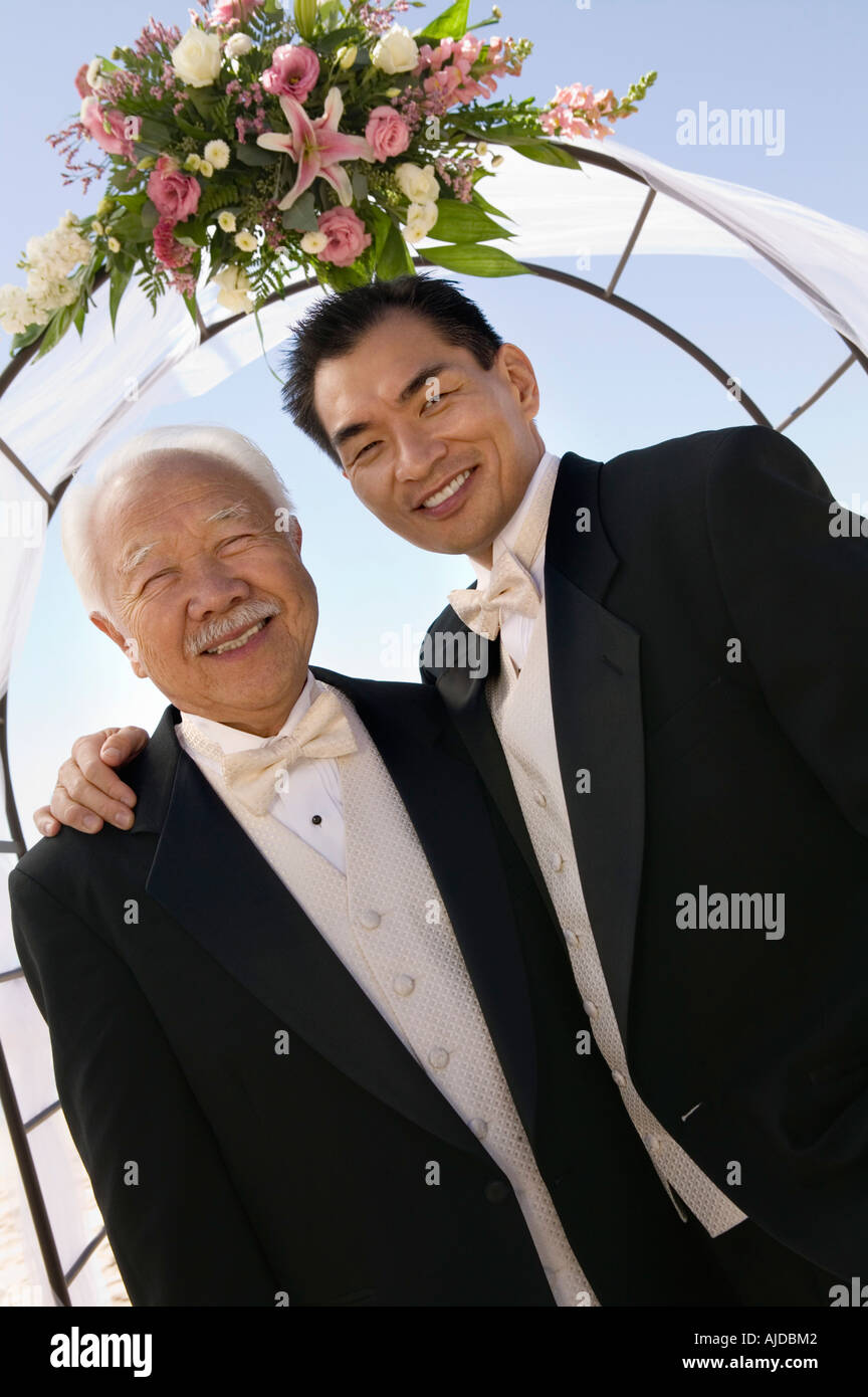 Groom with father under archway, outdoors, (portrait Stock Photo - Alamy