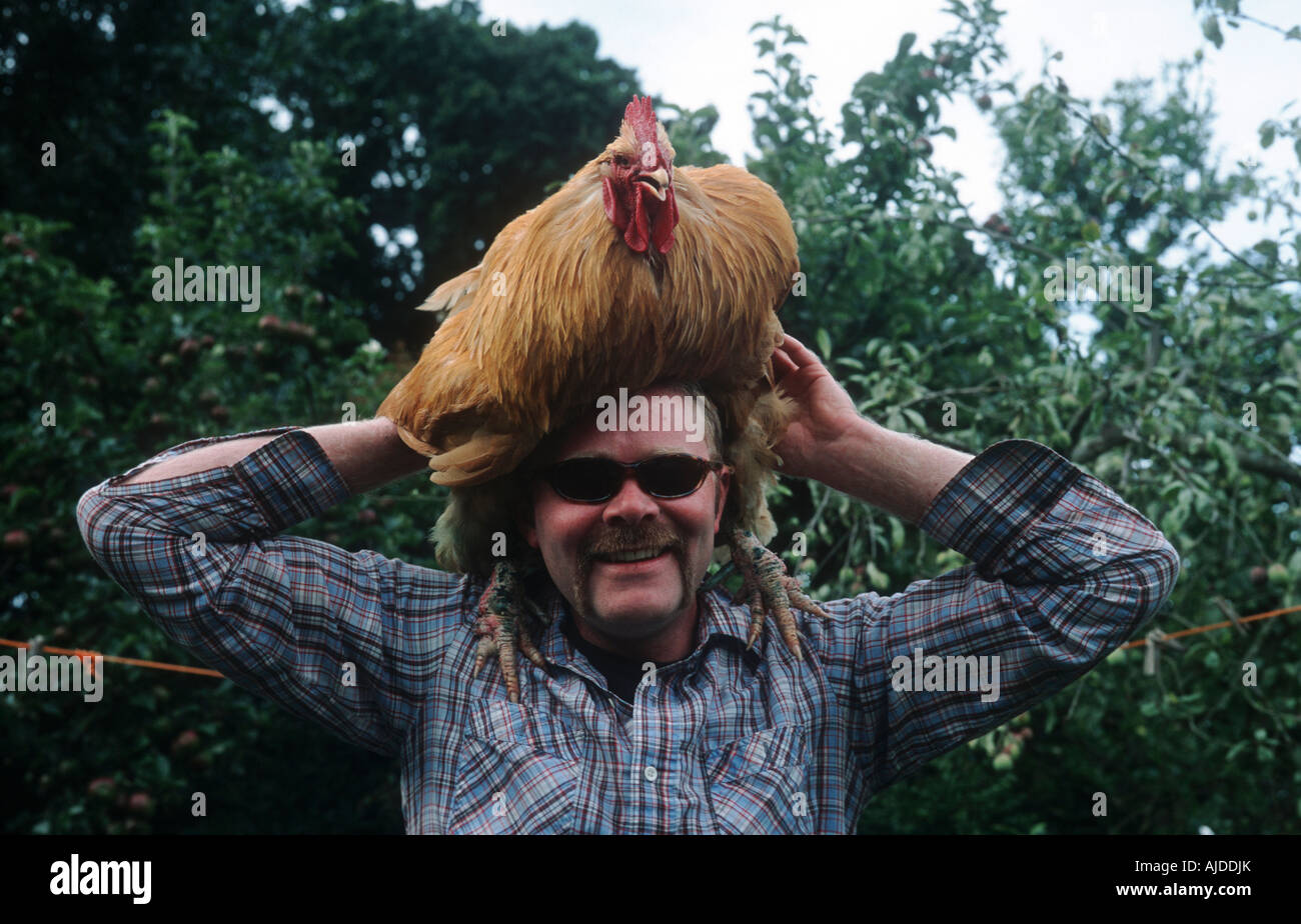 Man posing with chicken on his head Stock Photo - Alamy