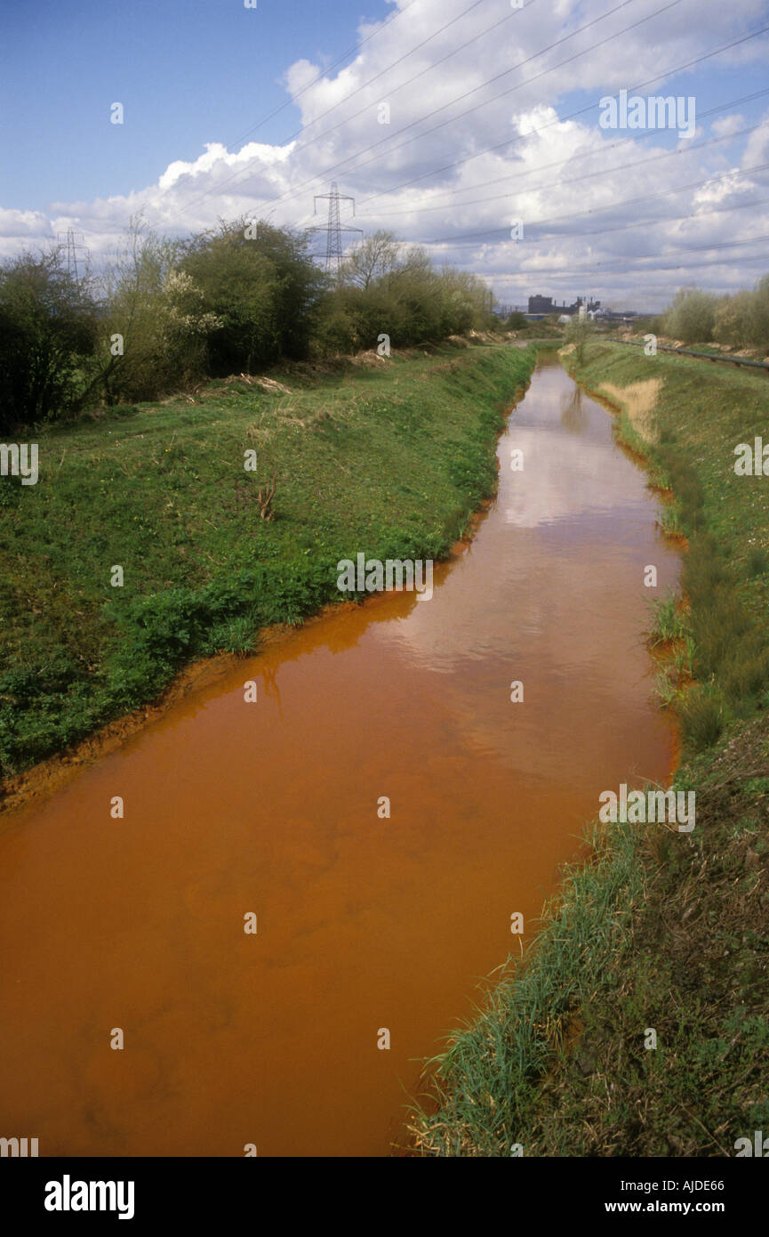 Iron staining polluting water near steelworks Newport South Wales UK ...