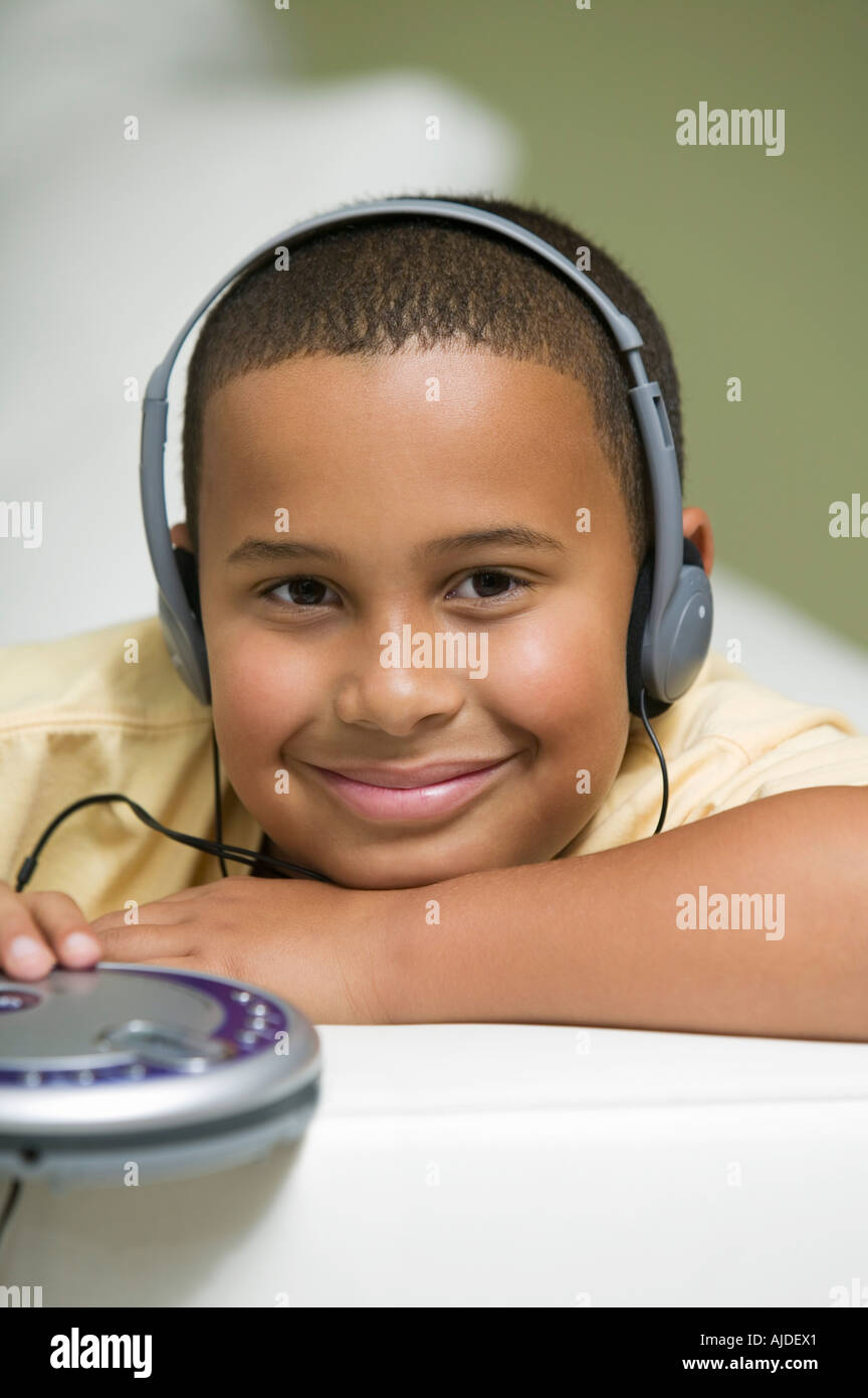 Boy on sofa Listening to portable CD player, portrait Stock Photo - Alamy