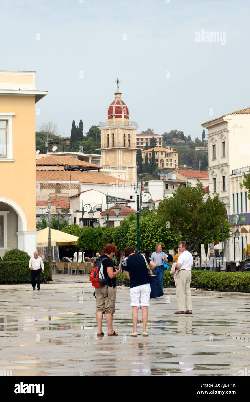 Tourists looking at a map in Solomos Square, Zakynthos town, Greece ...
