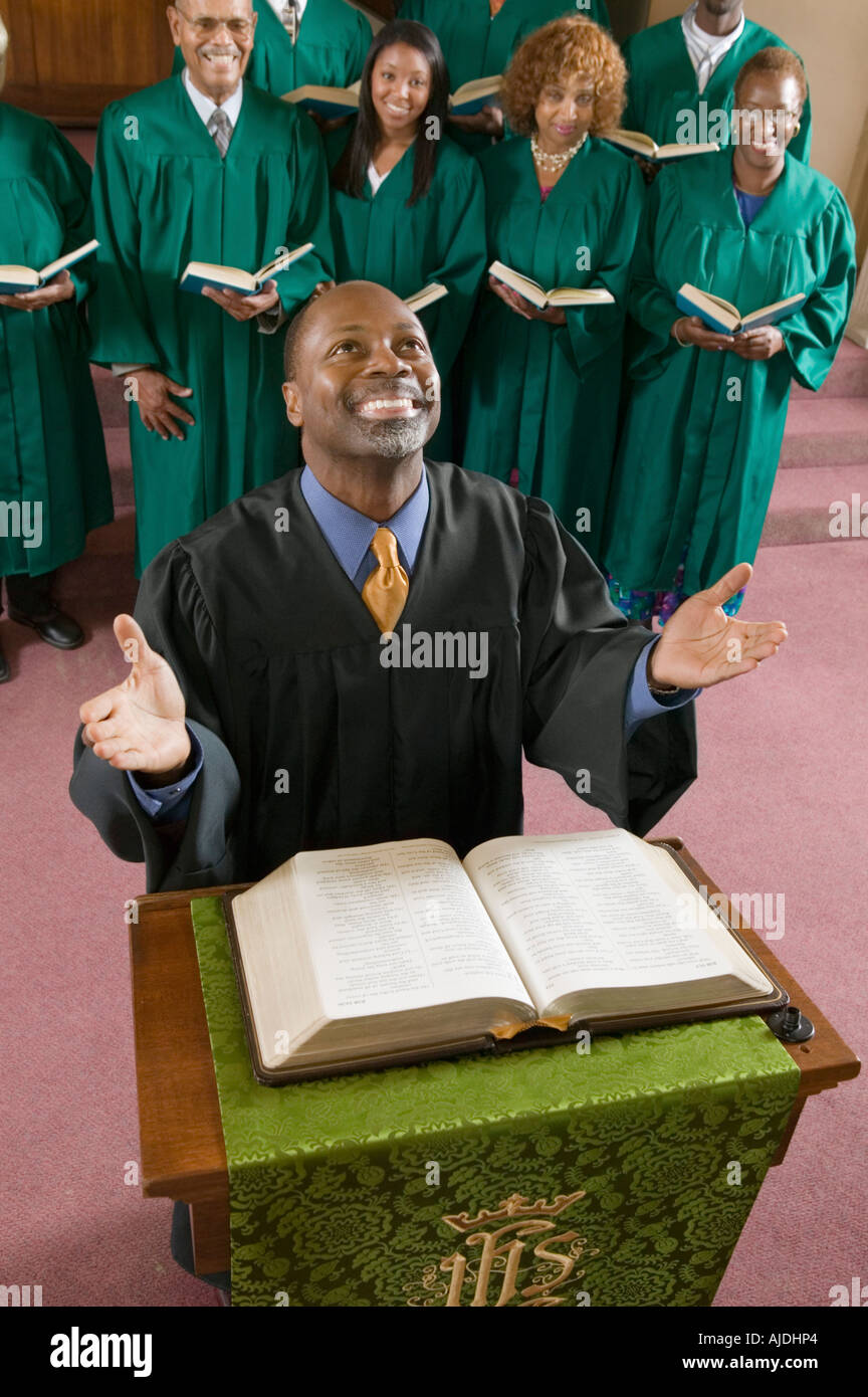 Happy preacher with Bible at church altar looking up, high angle view ...