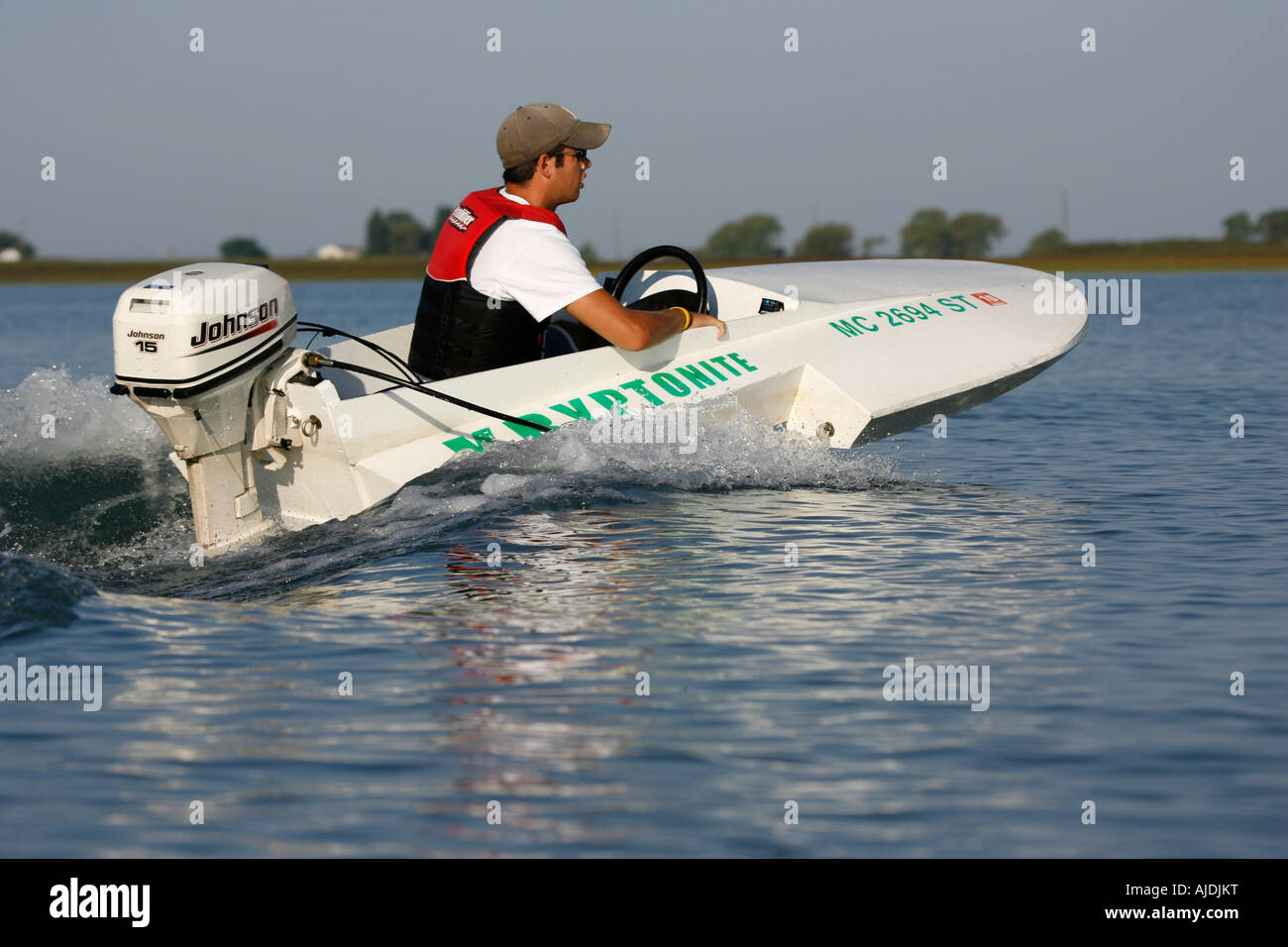 Teenage boy driving his hydroplane on a lake Stock Photo - Alamy