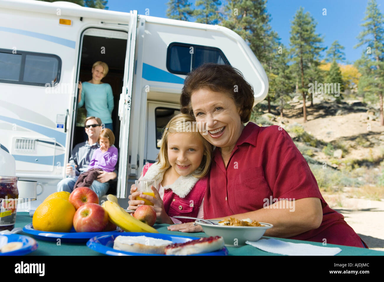 Three-generation family outside RV in campground Stock Photo - Alamy