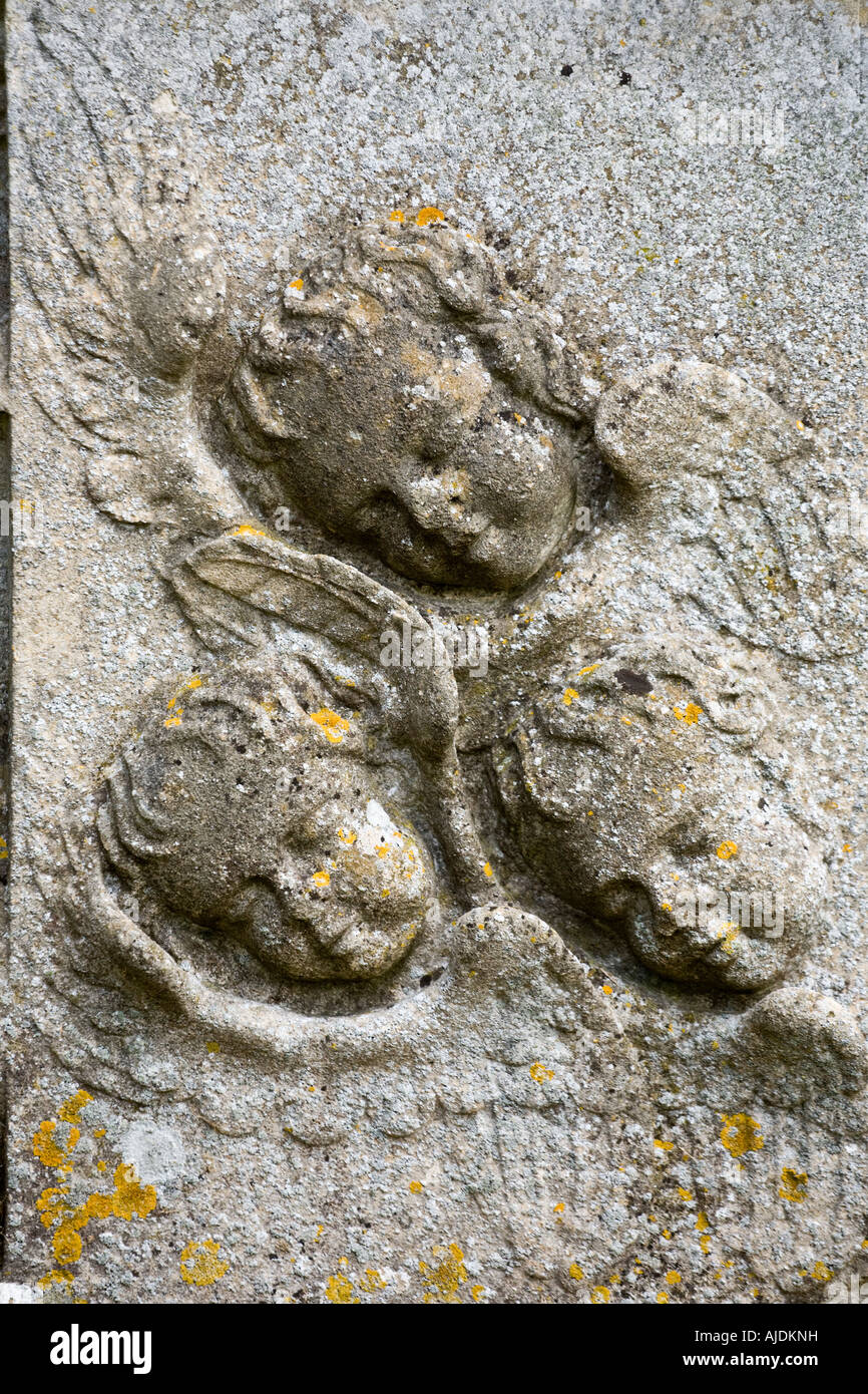 Three cherubs carved on the side of a tomb in the churchyard of the ...