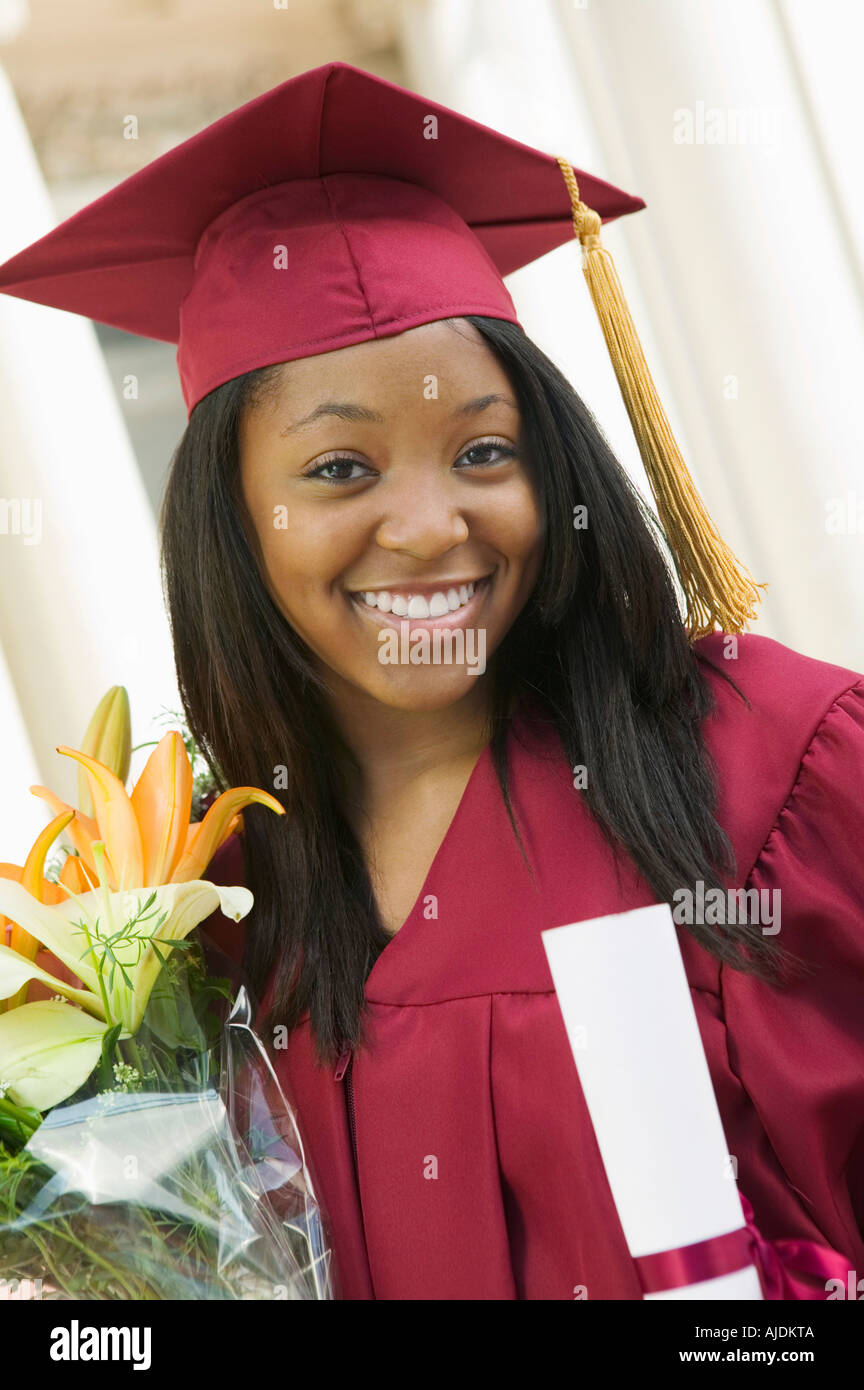 Graduate holding diploma flowers hi-res stock photography and images ...