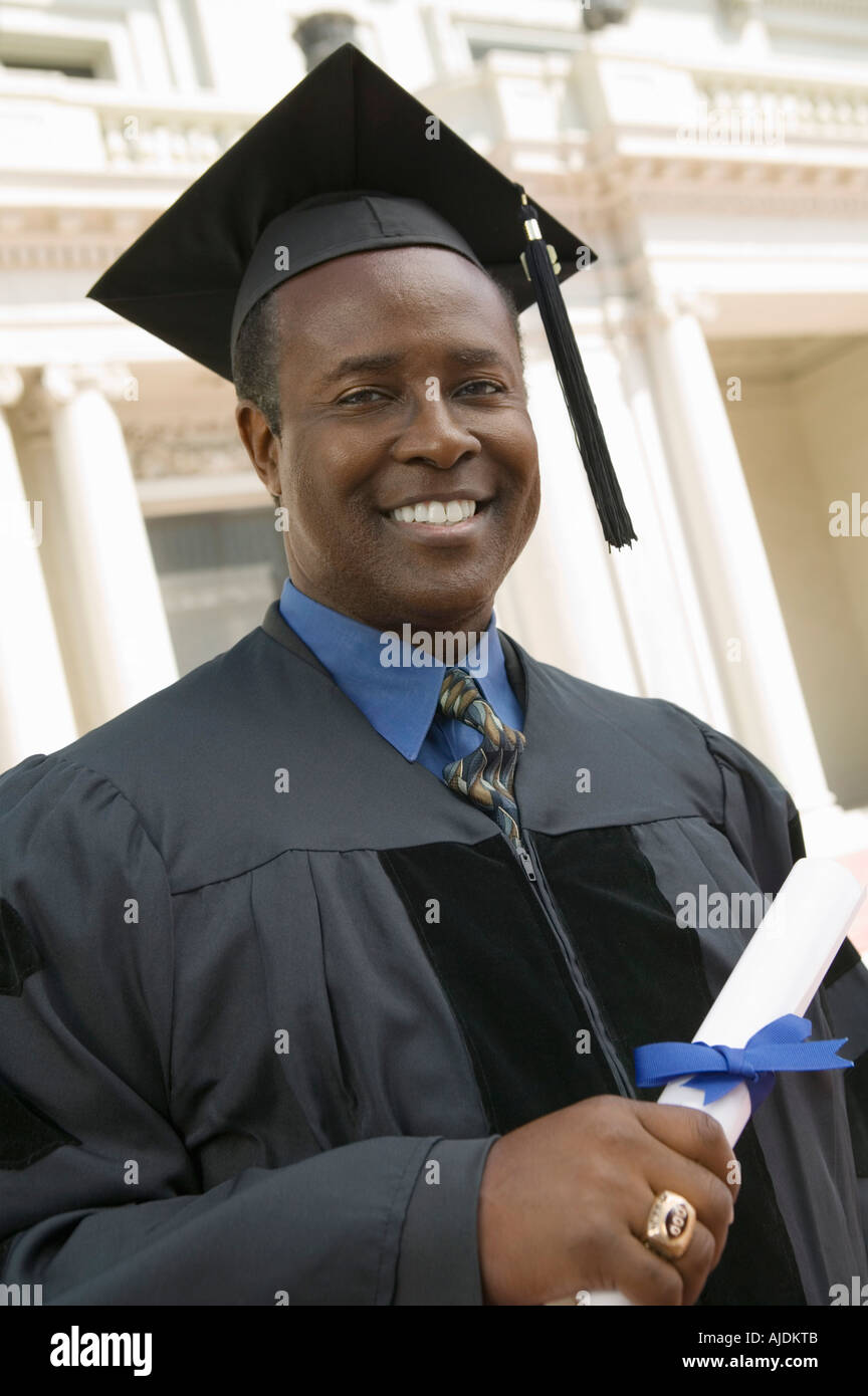 Graduate with Diploma outside university, portrait Stock Photo - Alamy