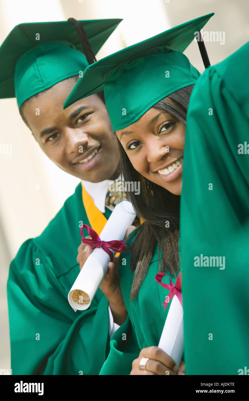 Two graduates with diplomas outside Stock Photo - Alamy