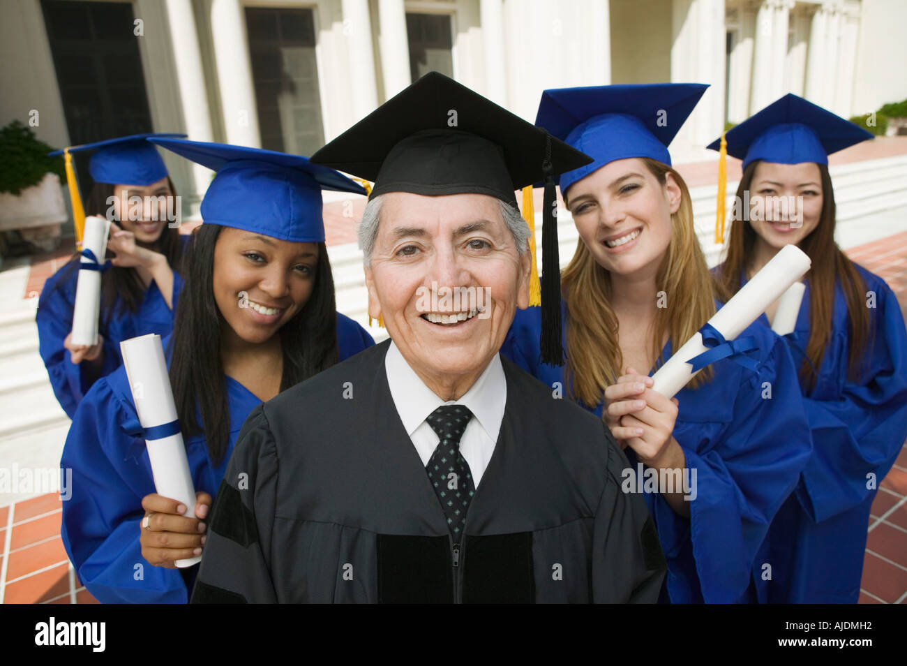 Dean and graduates outside university, elevated view, portrait Stock ...