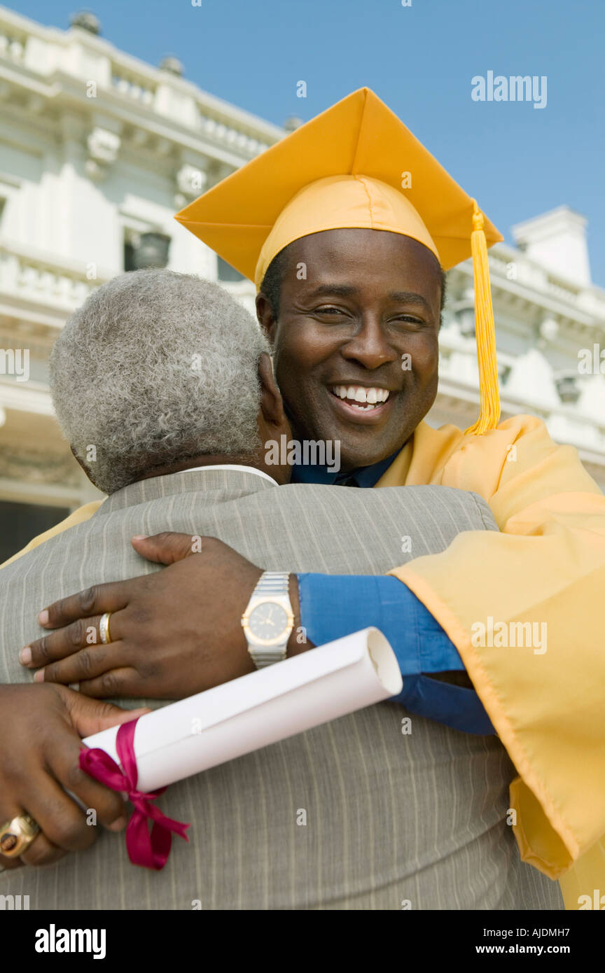 Graduate hugging father outside university Stock Photo - Alamy