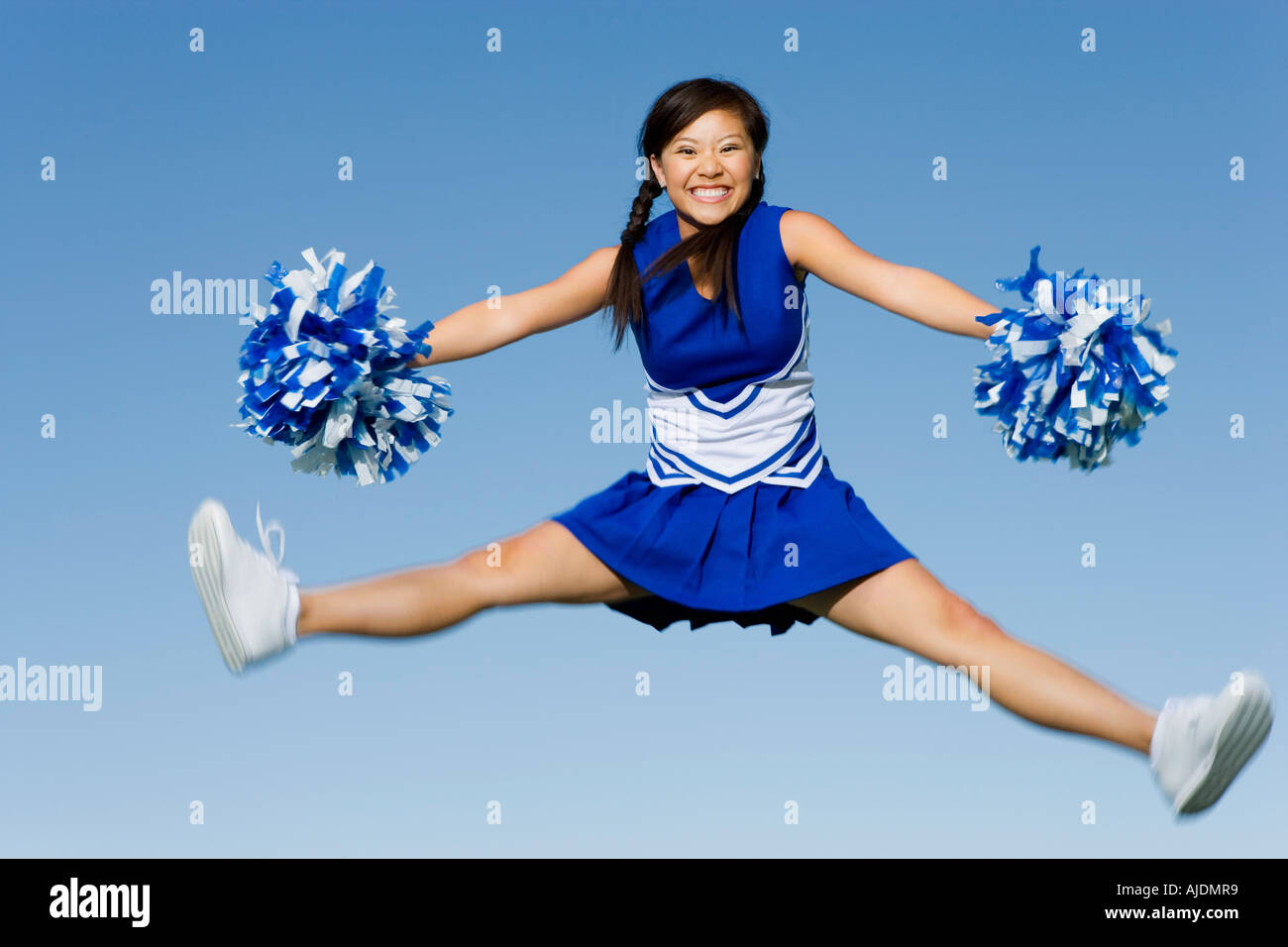 Smiling Cheerleader jumping in mid-air, (portrait Stock Photo - Alamy
