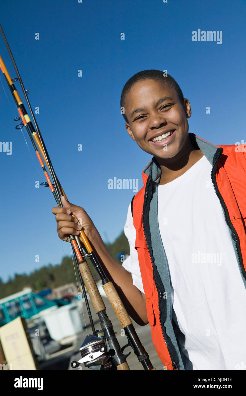 Boy holding fishing rod hi-res stock photography and images - Alamy