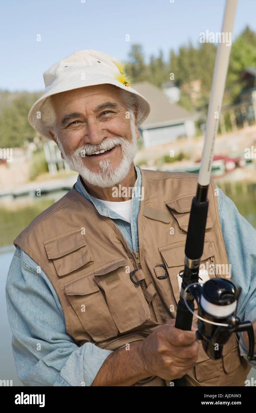 Middle-aged man fishing, smiling, (portrait Stock Photo - Alamy