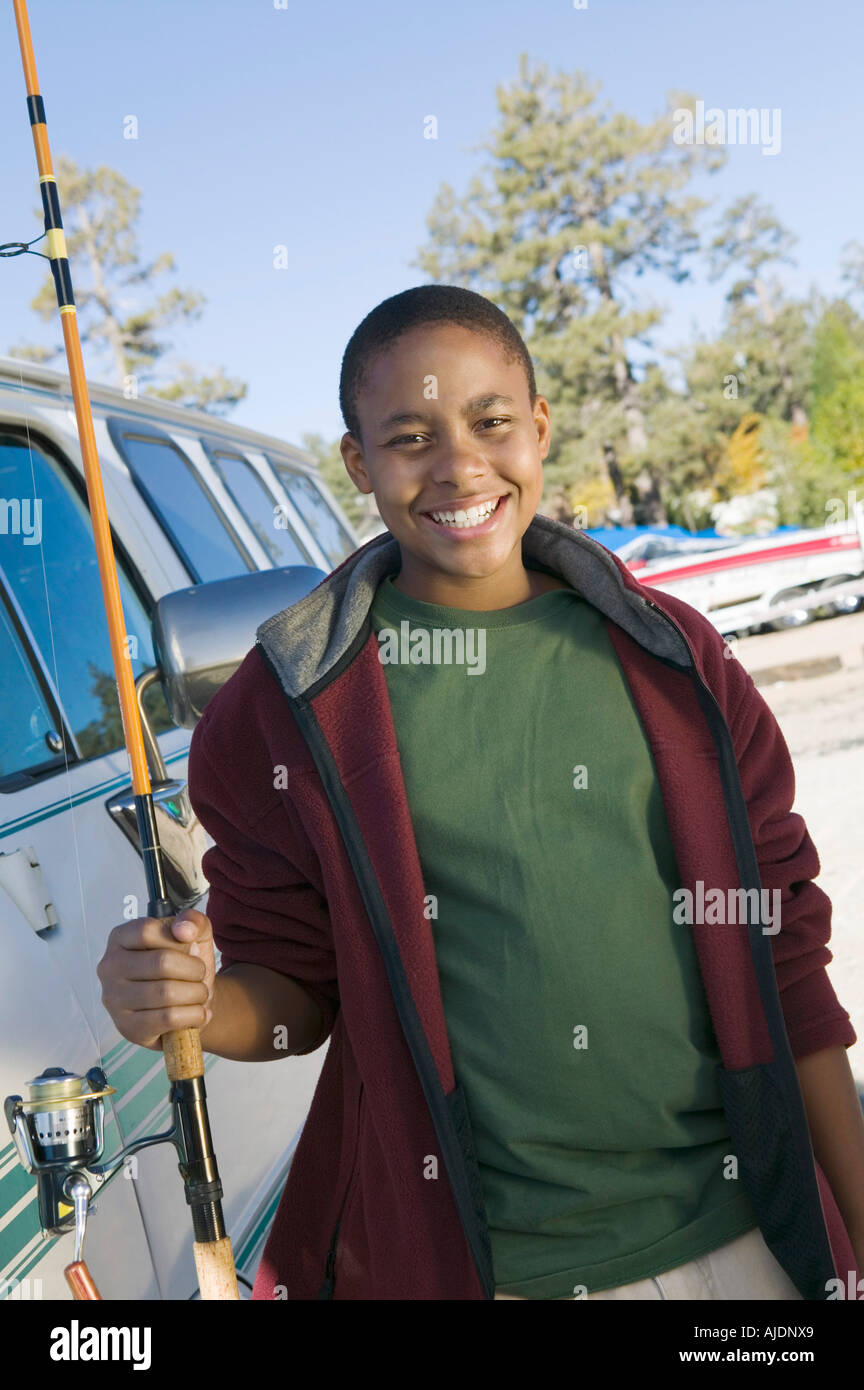Boy holding fishing rod, smiling, (portrait Stock Photo - Alamy