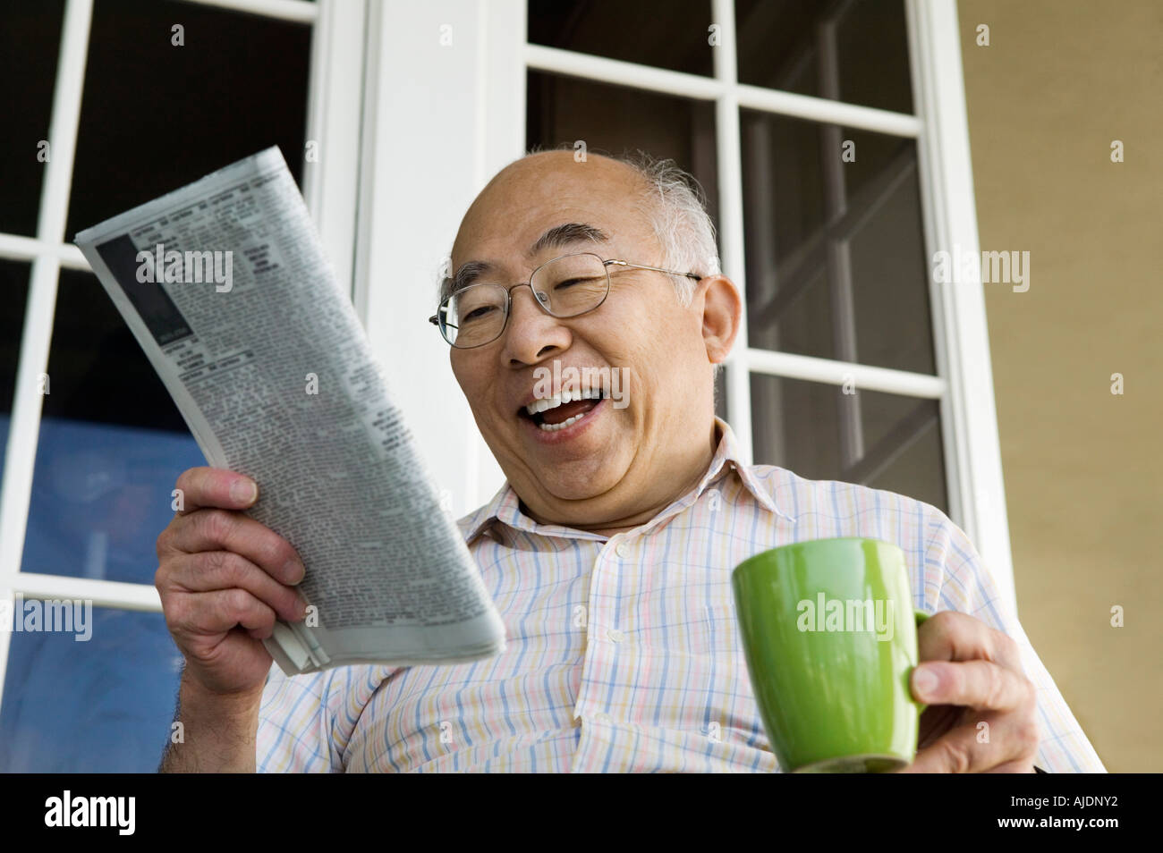 Person reading newspaper and laughing hi-res stock photography and ...