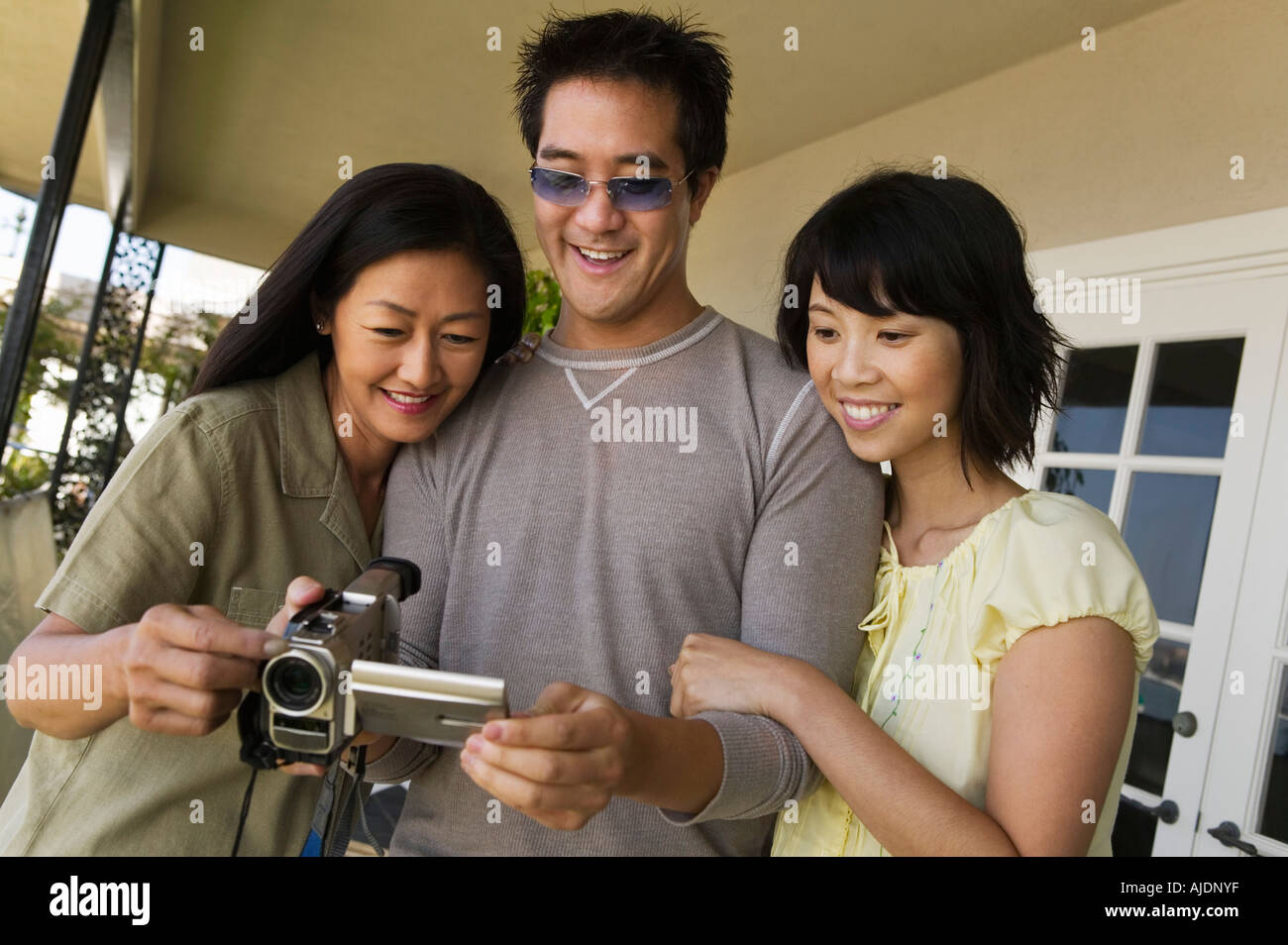 Family watching video on video camera Stock Photo - Alamy