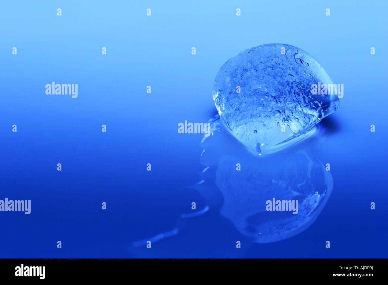 cold ice cube melting on blue background copy space Stock Photo - Alamy