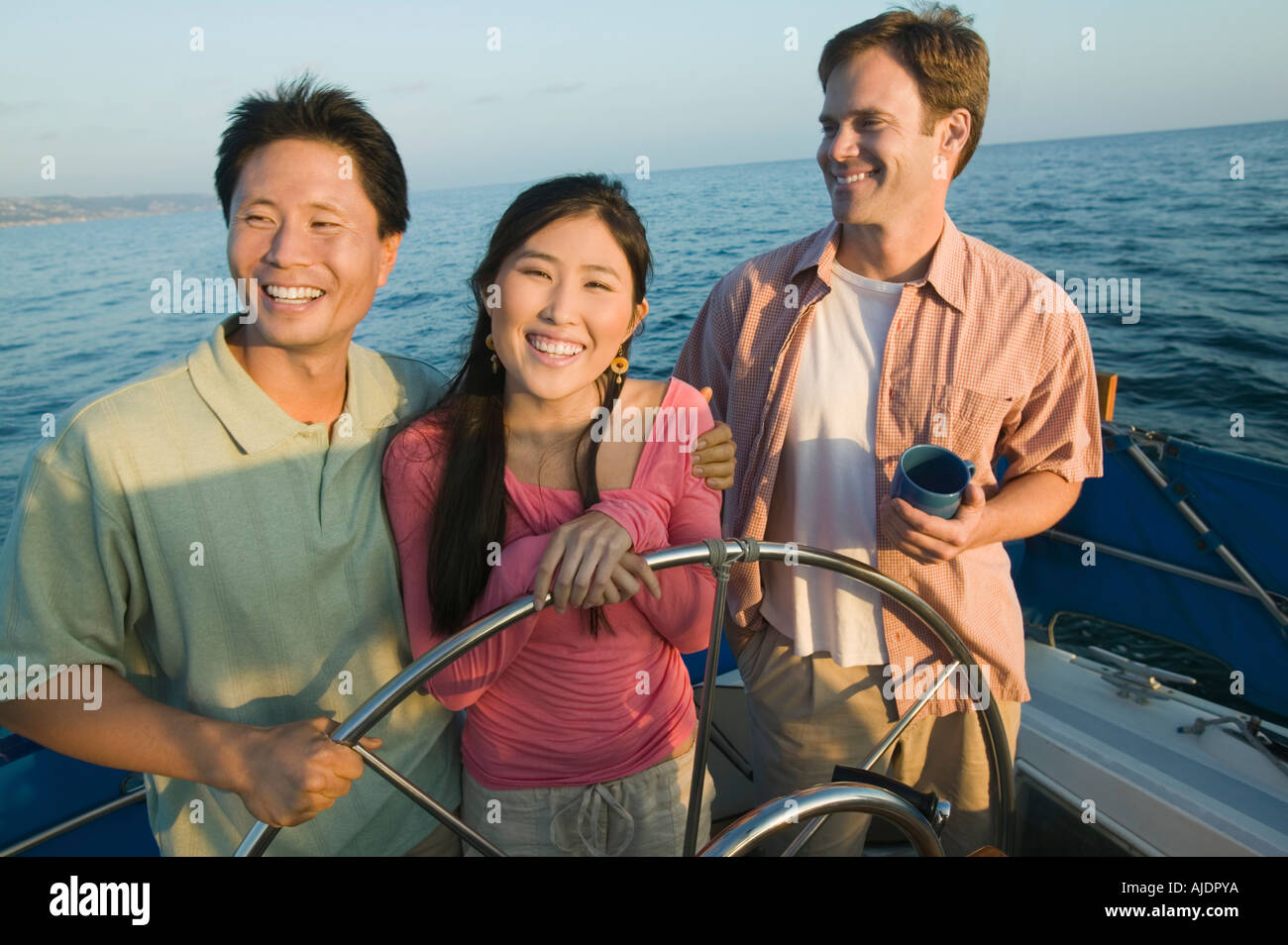 Couple with friend on yacht, (portrait Stock Photo - Alamy
