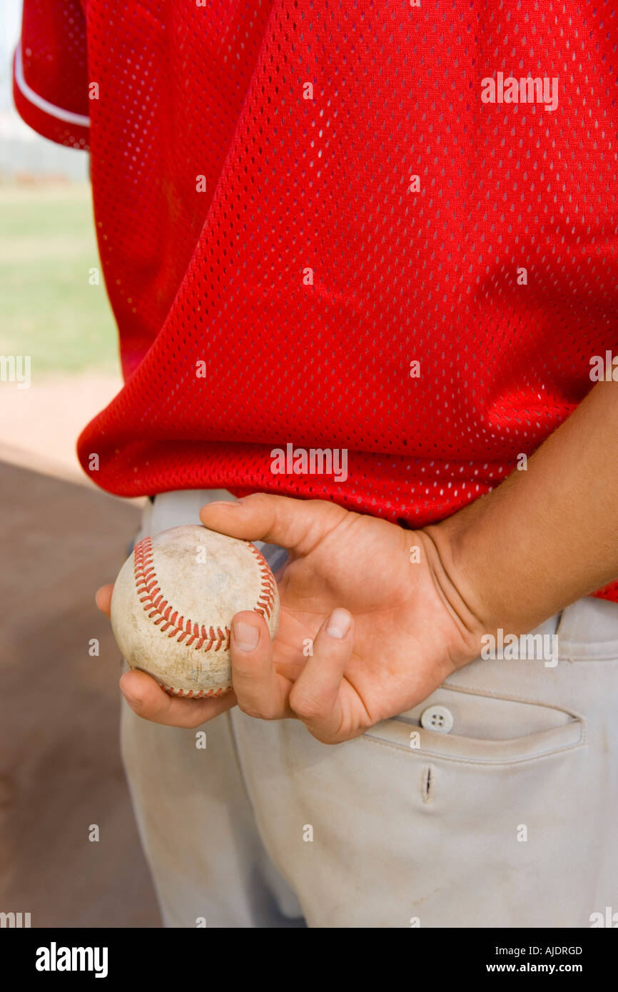 Baseball pitcher holding ball, (close-up), (mid section Stock Photo - Alamy