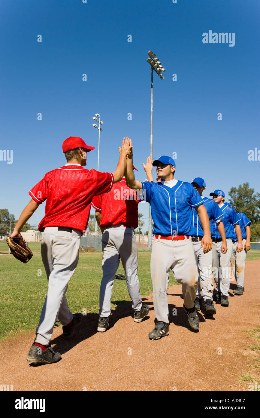 Line of baseball players giving each other high fives Stock Photo - Alamy