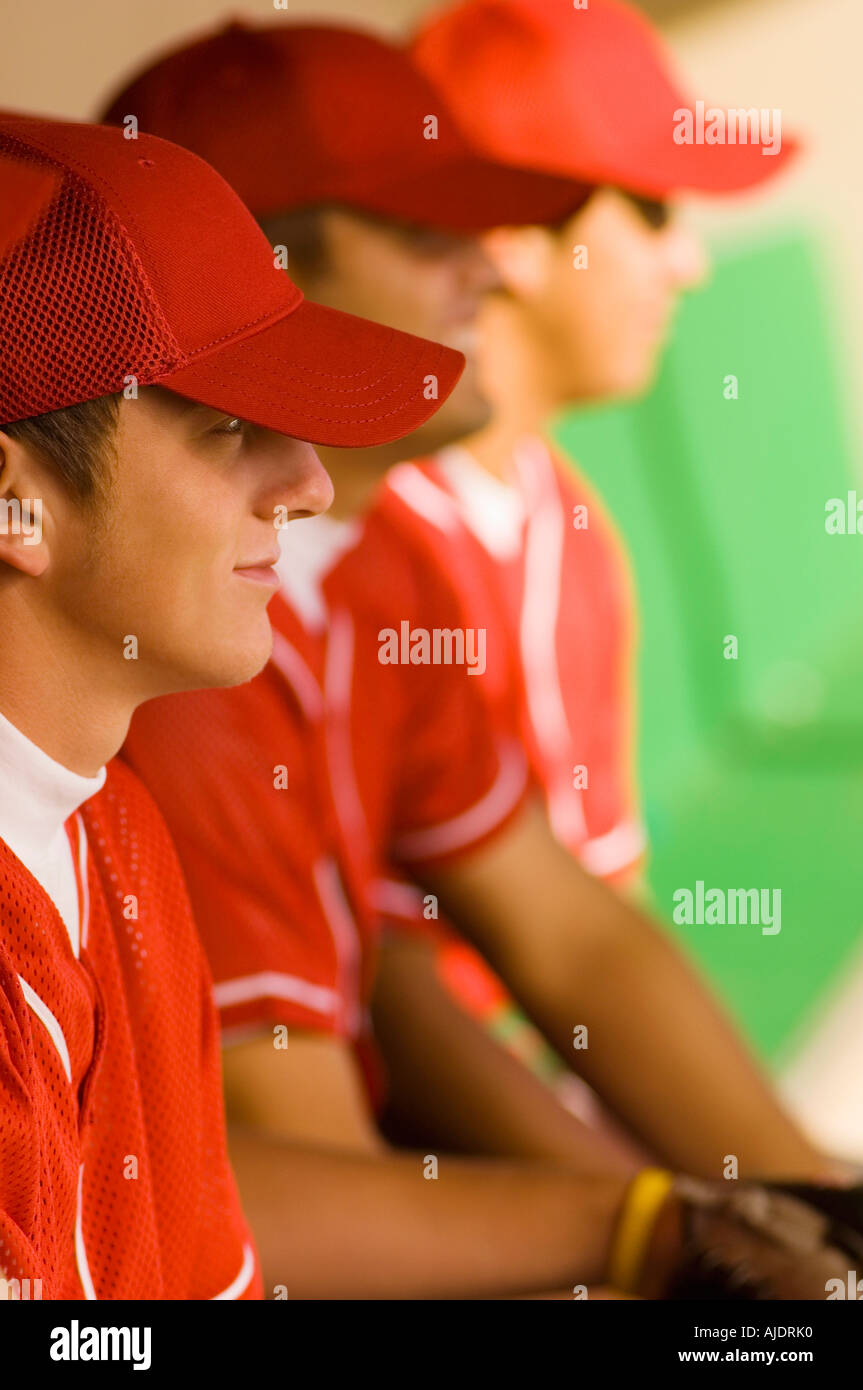 Baseball team-mates sitting in dugout Stock Photo - Alamy