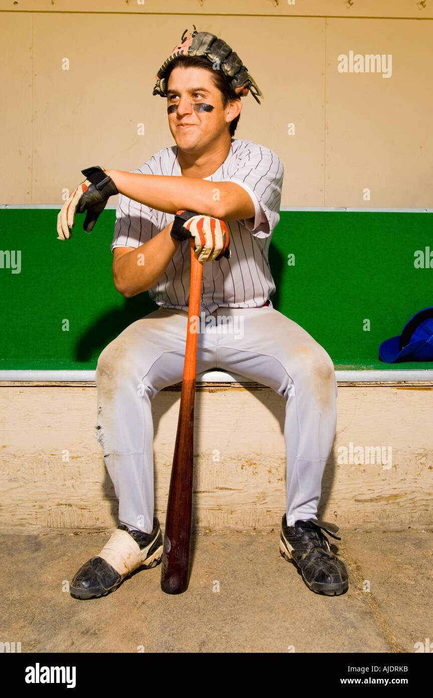 Baseball player sitting in dugout Stock Photo - Alamy