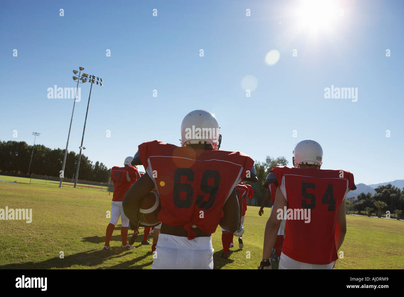 Football Players walking onto Field, back view Stock Photo - Alamy