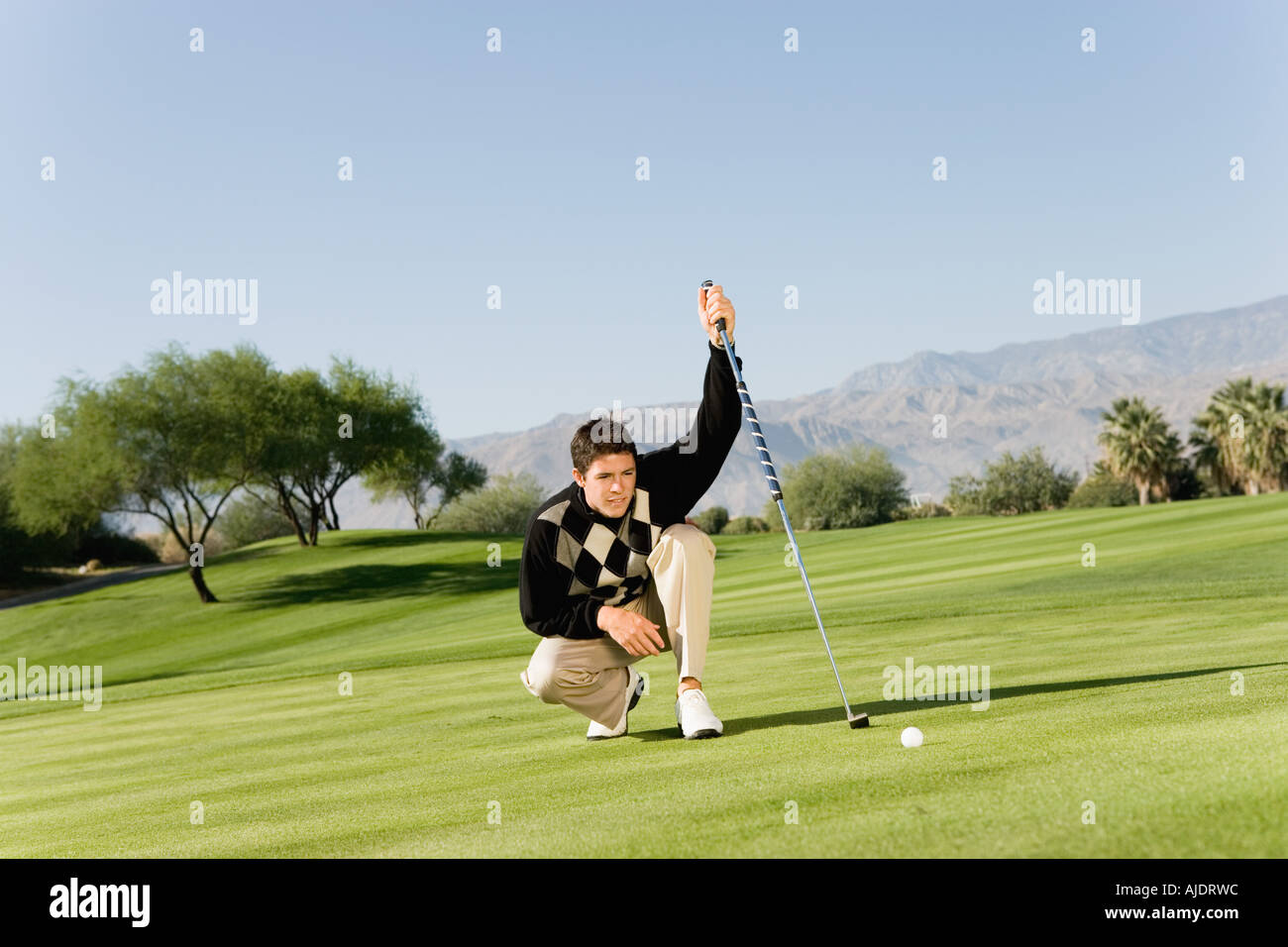 Golfer lining up putt hi-res stock photography and images - Alamy