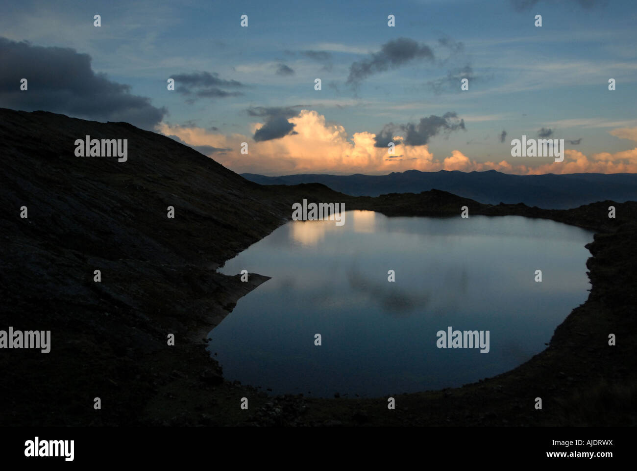 Sunrise is reflected off of Lake Chillata located below Mt Illampu near ...