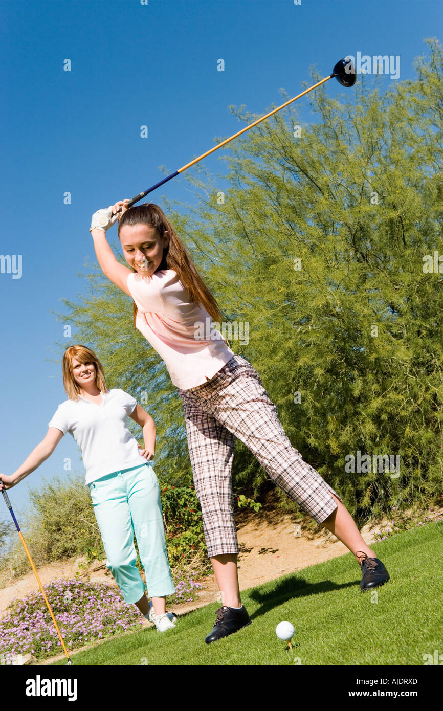 Female golfer teeing off Stock Photo - Alamy