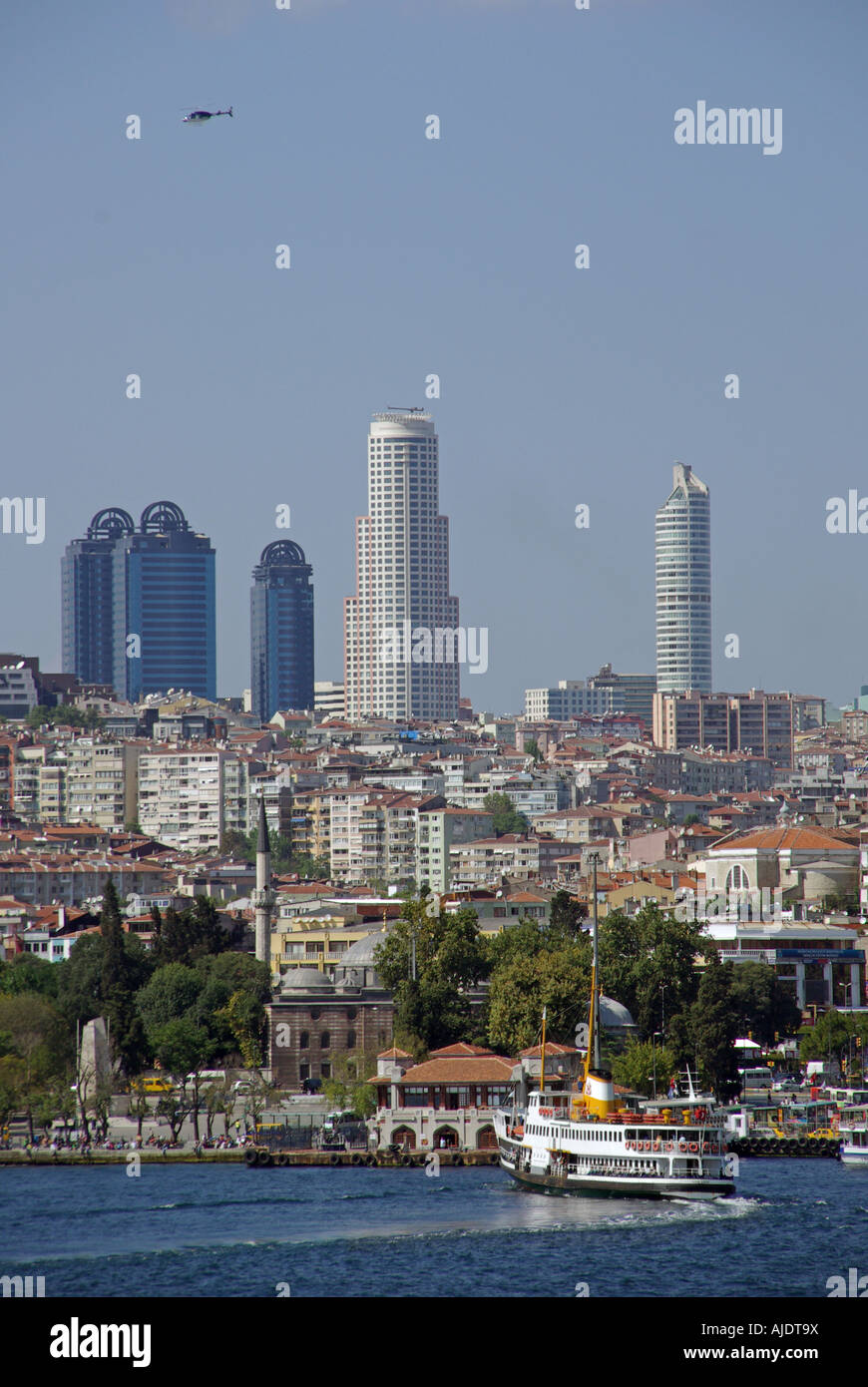 Istanbul Mosque beside the Bosphorus with high rise buildings ...