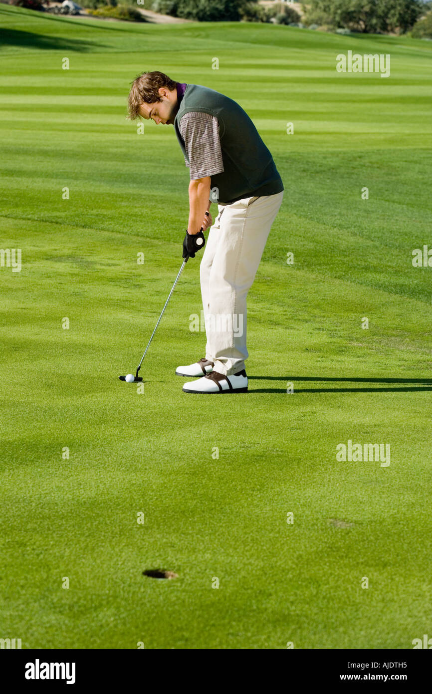 Golfer putting on golf course's green Stock Photo - Alamy